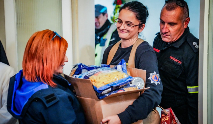 Law enforcement officers collect and distribute food to those in need